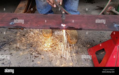 Creating Holes With Torch For Bulding Down Steel Plow Edge Stock Photo Alamy