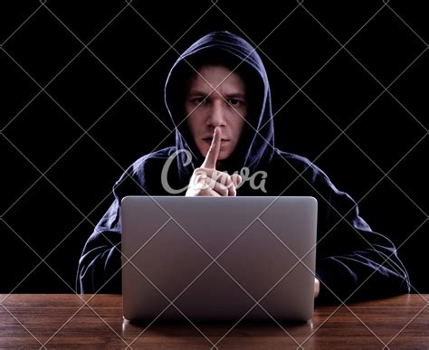 hooded computer hacker stealing information photos by canva