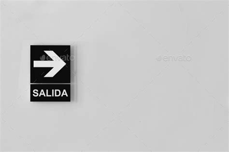 Grayscale Shot Of An Exit Salida Sign In Spanish With Right Arrow