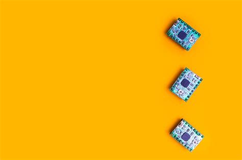 Premium Photo Three Microcircuit Over Orange Background Minimal Engineering Concept