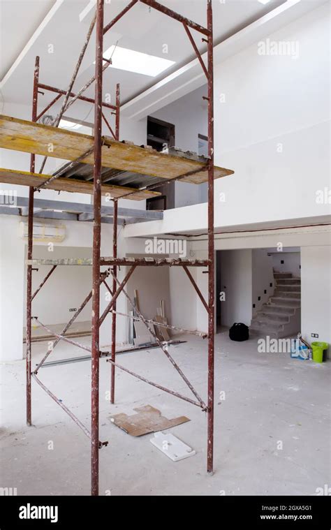 Interior Of Construction Site With Scaffolding In A Large Modern Unfinished Duplex Apartment