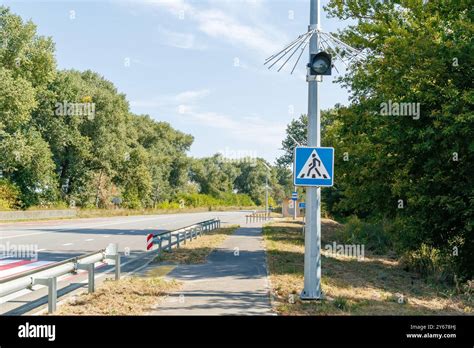 A Yellow Traffic Light Is Flashing Against A Clear Sky Countdown Timer Unregulated Pedestrian