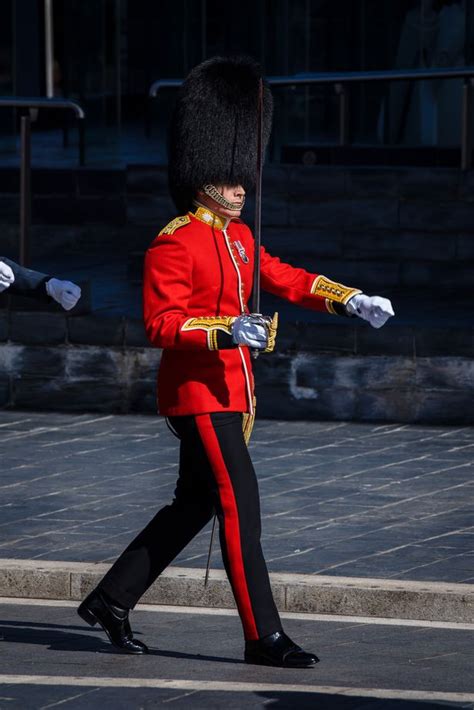 Gruesome Reason Why Queens Guards Wear Helmet Straps Under Chin In