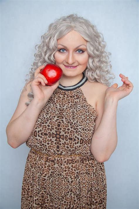 Chubby Blonde Girl Wearing Summer Dress And Posing With Big Red Apple On White Background Alone