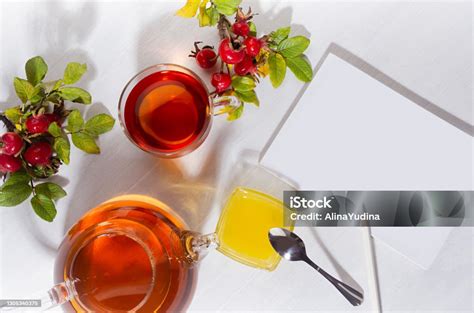 컵 개 장미 가지와 부드러운 밝은 흰색 나무 테이블 상단보기에 그림자빈 스케치 북 찻주전자에 장미 엉덩이 차와 아늑한 가을 티타임 복사 공간 가벼운에 대한 스톡 사진 및