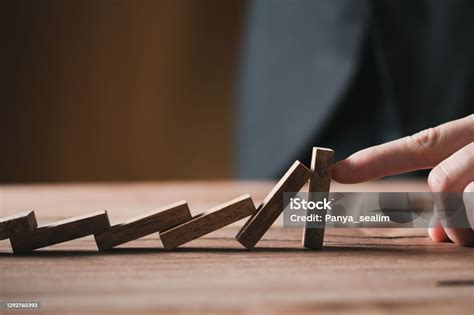 나무 게임 전략 사업가 손 지속적인 토플 또는 위험 전략과 비즈니스에 대한 성공적인 개입 개념에서 떨어지는 나무 도미노 효과를 중지 이미지 개념에 대한 스톡 사진 및 기타