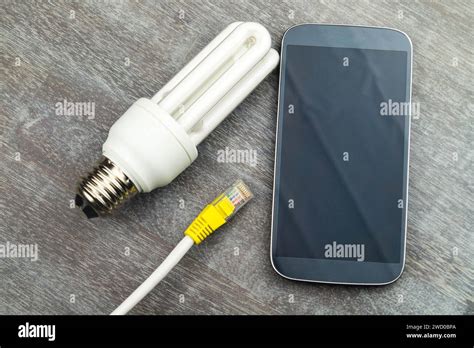 Energy Saving Lamp Smart Phone And Network Plug Symbolic Image For