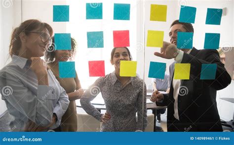 Diverse Team People Looking At Sticky Notes On Glass Brainstorming