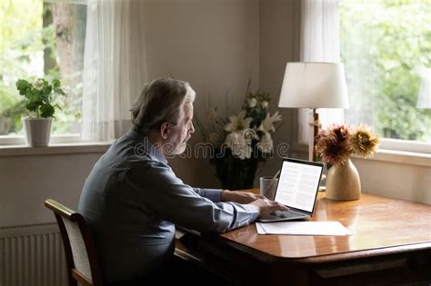 Mature Aged Man Writer Typing On Laptop Working On Book Stock Image Image Of Office Elderly