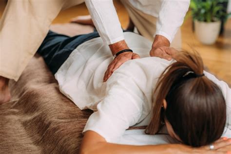 Premium Photo Woman Enjoying Shiatsu Back Massage Lying On The