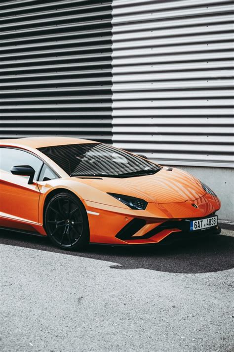 Sleek Orange Sports Car Urban Wallpaper Background Free Download