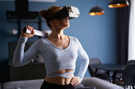 Young Futuristic Blonde Girl Wearing Virtual Reality Headset Holding