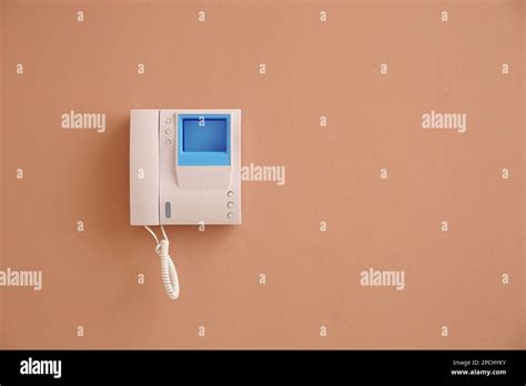 Modern Intercom System With Handset On Beige Wall Space For Text Stock