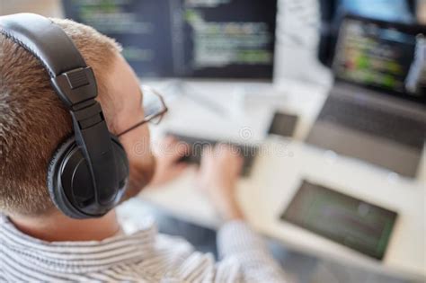 Man Wearing Headphones While Working On Computer Code Stock Photo Image Of Software Coding