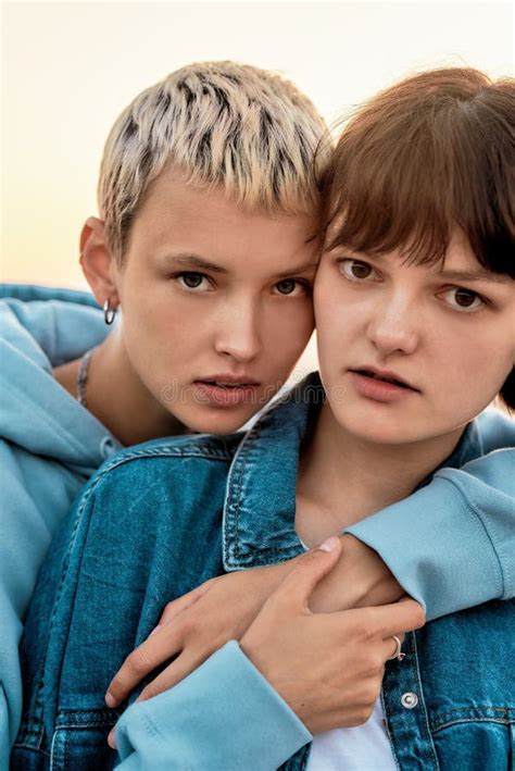 Portrait Of Two Attractive Young Women With Short Hair Looking At