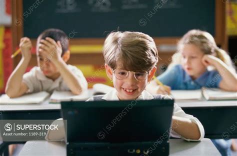 Girl Using A Laptop In A Classroom SuperStock