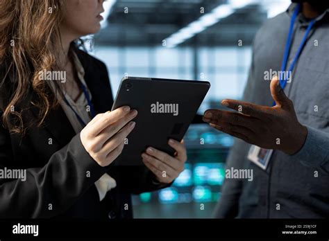 Teamworking Employees In Data Center Facility Use Tablet Configuring Rigs Network
