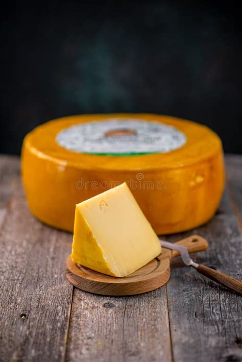 Medium Hard Cheese Head Edam Gouda Parmesan On Wooden Board With Knife