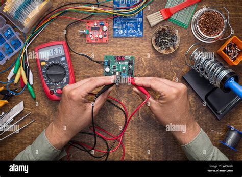Hands Measuring Power Supply Voltage With Tester DIY Electronics Repair Making Concept Stock