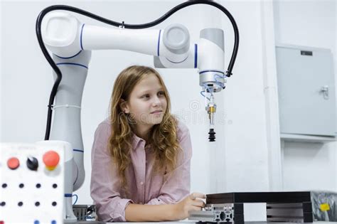 Girl Caucasoid Education Electronic Robotic Arm On Table At Class Room Learning Innovation