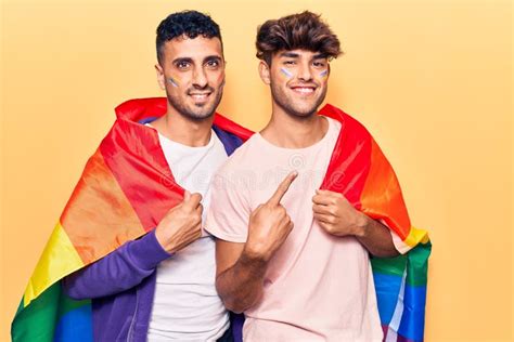Young Gay Couple Wearing Rainbow Lgbtq Flag Smiling Happy Pointing With