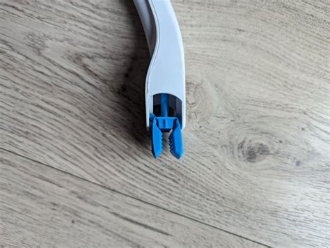 60cm Long White Plastic Handled Tool With Blue Plastic Gripping Jaws The Jaws Are Operated By