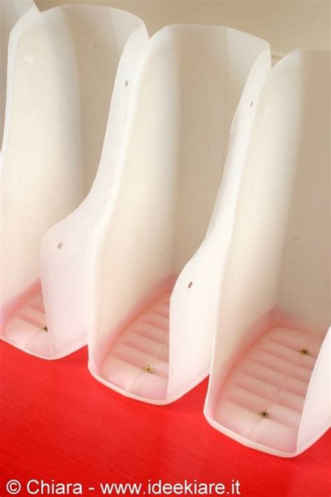 Five White Urinals Lined Up On A Red Table