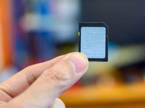 Premium Photo Cropped Hand Holding Memory Card