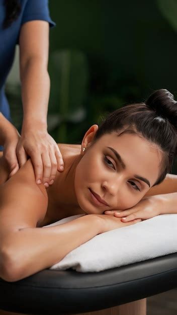 Young Woman Receiving A Back Massage In A Spa Center Premium Ai