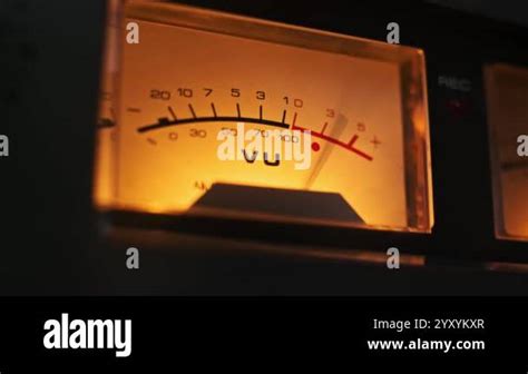 Detailed Close Up Of A Glowing Analog Vu Meter Emphasizing Warm Tones