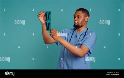 Male Nurse Talking With Patient Giving Him Radiology X Ray Scan