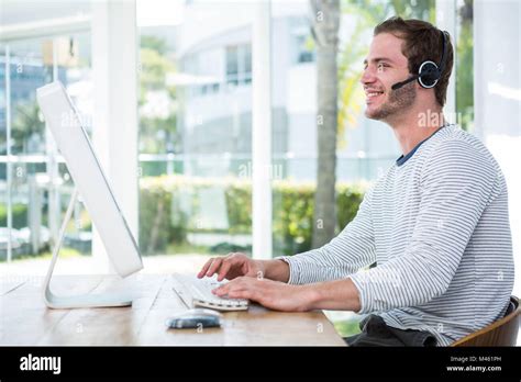 Handsome Man Working On Computer With Headset Stock Photo Alamy