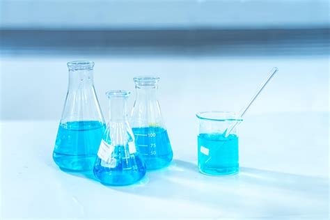 Premium Photo Blue Chemical In Containers On Table At Laboratory