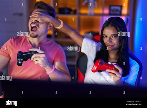 Man And Woman Streamers Playing Video Game Using Computer And Joystick Cheating At Gaming Room