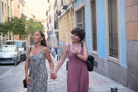 Beautiful Lesbian Couple Wearing Long Dresses Walking Holding Hands