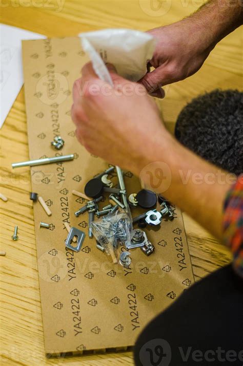 Furniture Assembly Man Holding Bolts Furniture Assembling Instructions And Tool High Quality