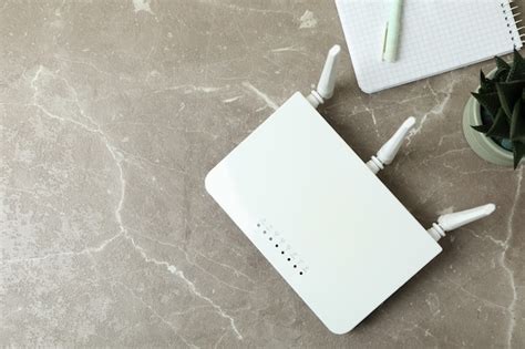 Premium Photo Workplace With Wi Fi Router On Gray Textured Table