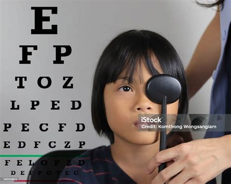 Elementary School Girl Wearing Eyeglasses Visual Acuity Test With Test Chart Eye Test Female