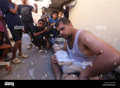 a palestinian man mourns the body of his two year old son yaman