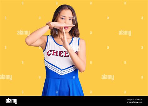 Young Beautiful Chinese Girl Wearing Cheerleader Uniform Doing Time Out