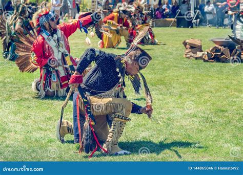 Men`s Traditional Dance Simulates A Warrior Performing Scouting Duties