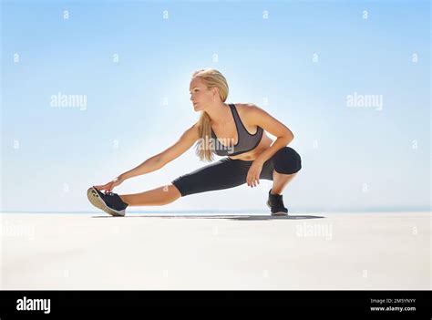 Stretching Out Her Leg Muscles Full Length Shot Of A Young Woman