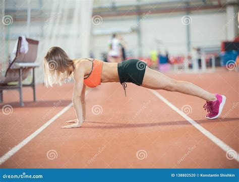 Young Fit Athletic Woman In Sports Clothes Doing Push Ups Side View