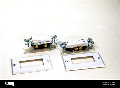 Switch And Socket Isolated Against White Background With Covers Lying Side By Side Stock Photo