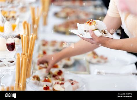 Close Up Of People Serving Themselves With Canapes In Restaurant