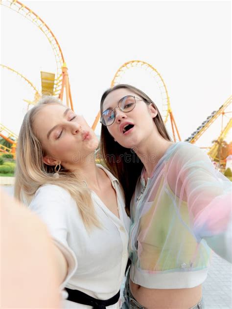 Two Teenage Girls Have Fun During Spend Time Together At Theme Park On