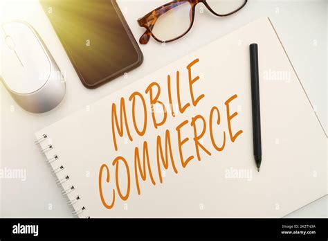 Text Sign Showing Mobile Commerce Word Written On Using Mobile Phone
