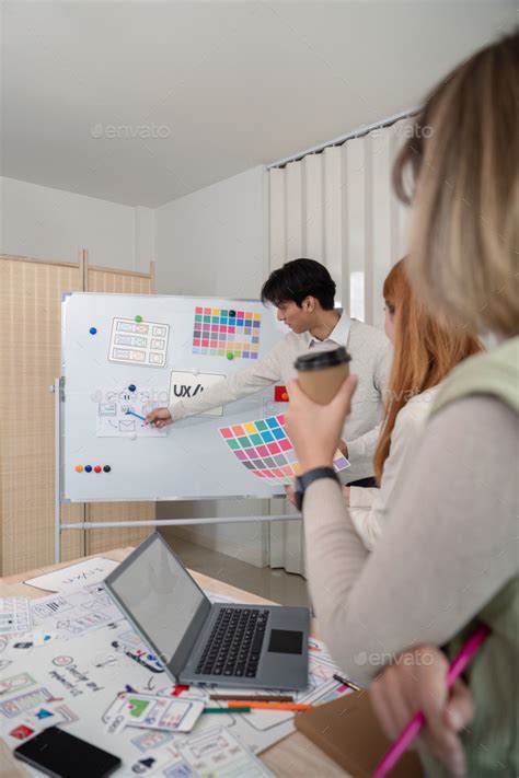 Creative Ux Developer And Ui Designer Brainstorming Session With Color Palettes And Wireframes