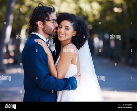 Interracial Wedding And Couple Kiss Portrait At Romantic Outdoor