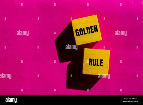 Golden Rule Message Written On Yellow Wooden Cubes With Pink Background Conceptual Golden Rule